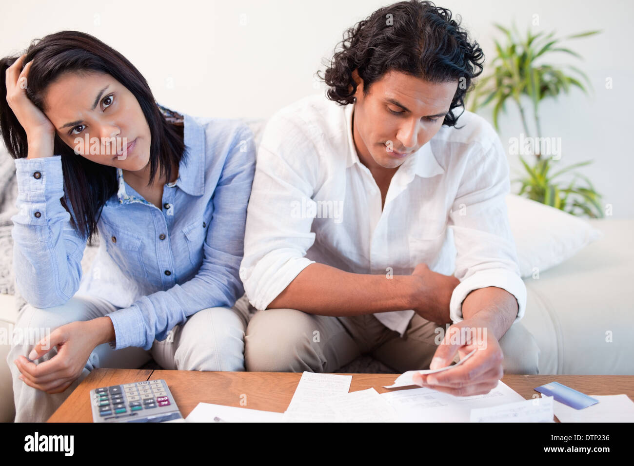 Sad couple checking their bills Stock Photo - Alamy