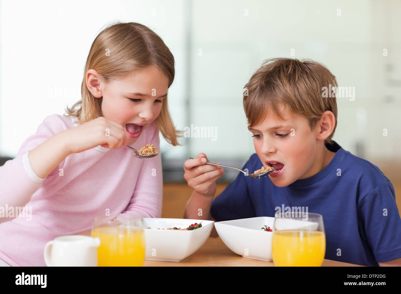 Children having fun at breakfast table hi-res stock photography and ...