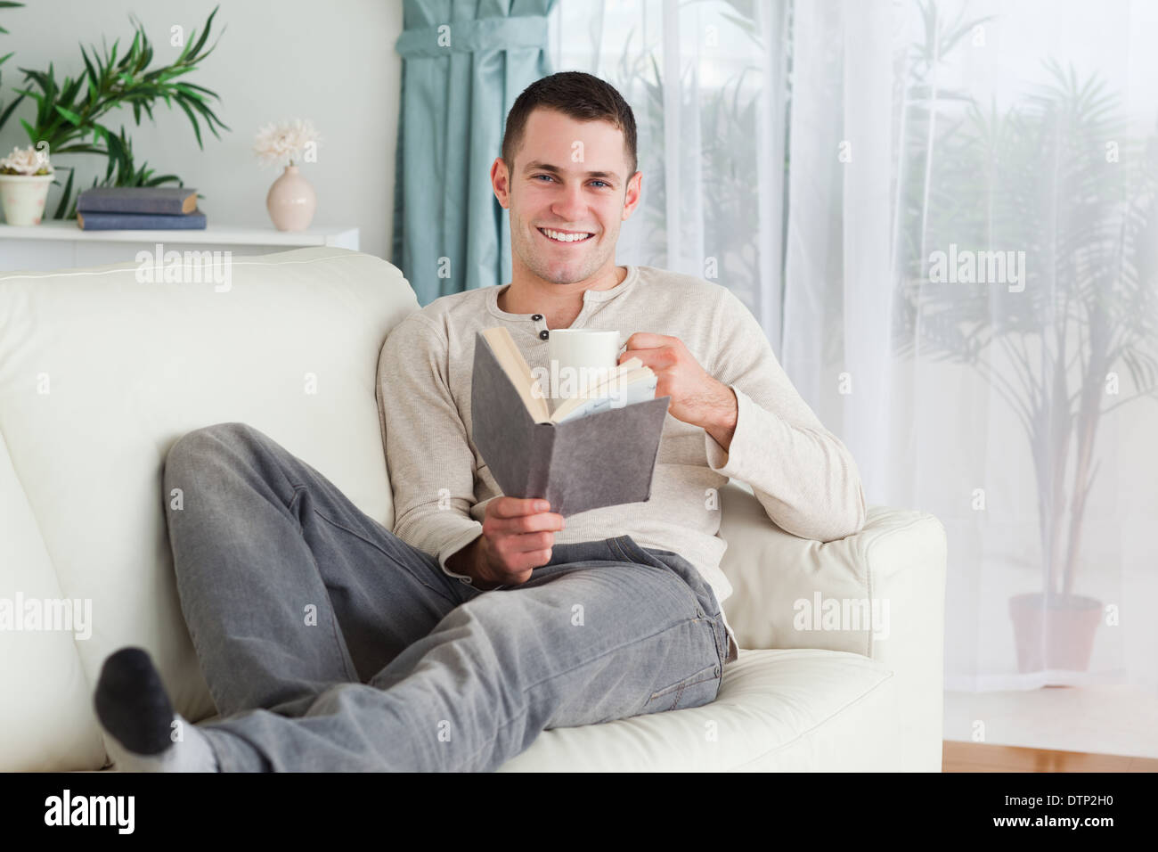 Happy man reading a book Stock Photo - Alamy