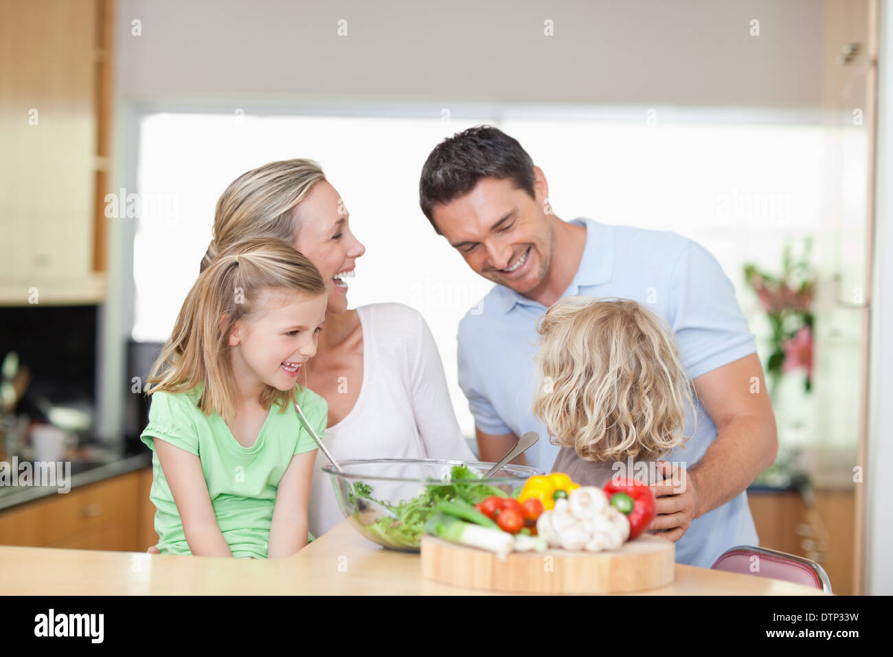 Happy family in the kitchen Stock Photo - Alamy