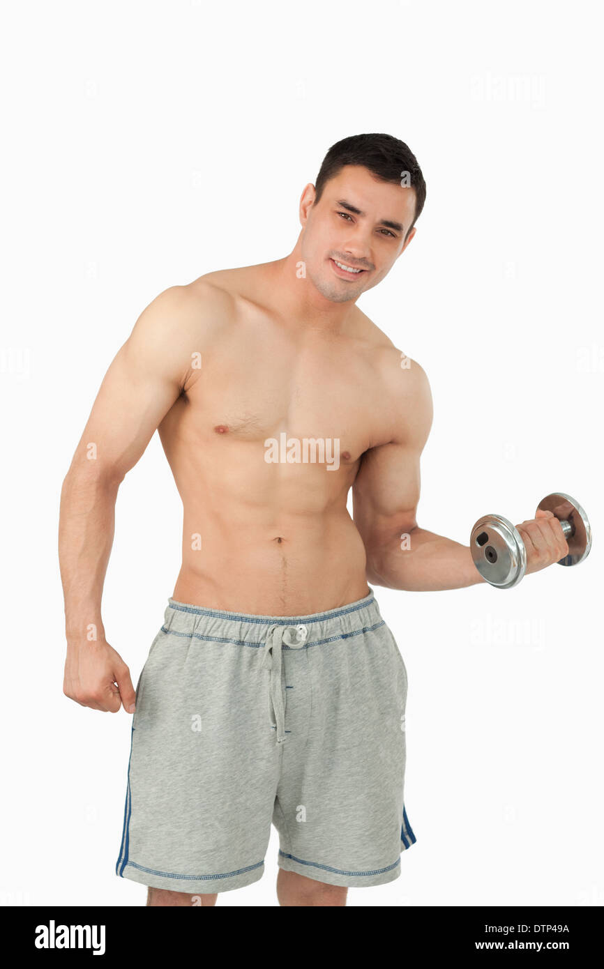 Young man doing weight lifting Stock Photo - Alamy