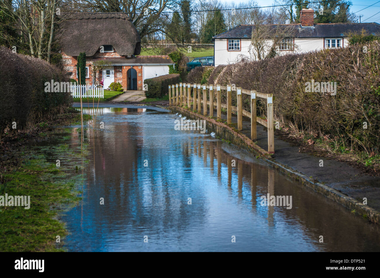 Water flooding across the road by that leads to deane hi-res stock ...