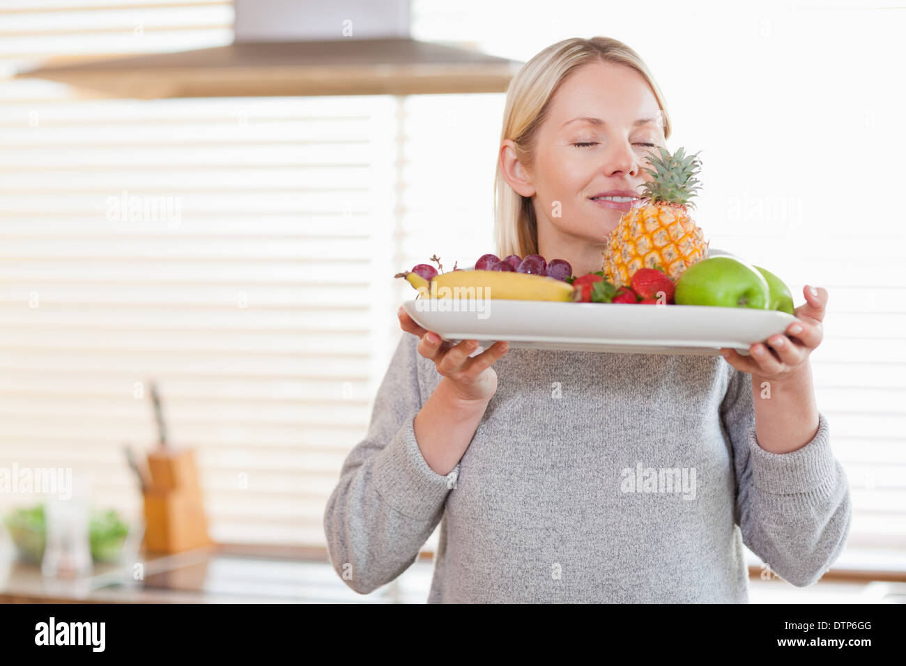 Woman smelling orange fruit hi-res stock photography and images - Alamy