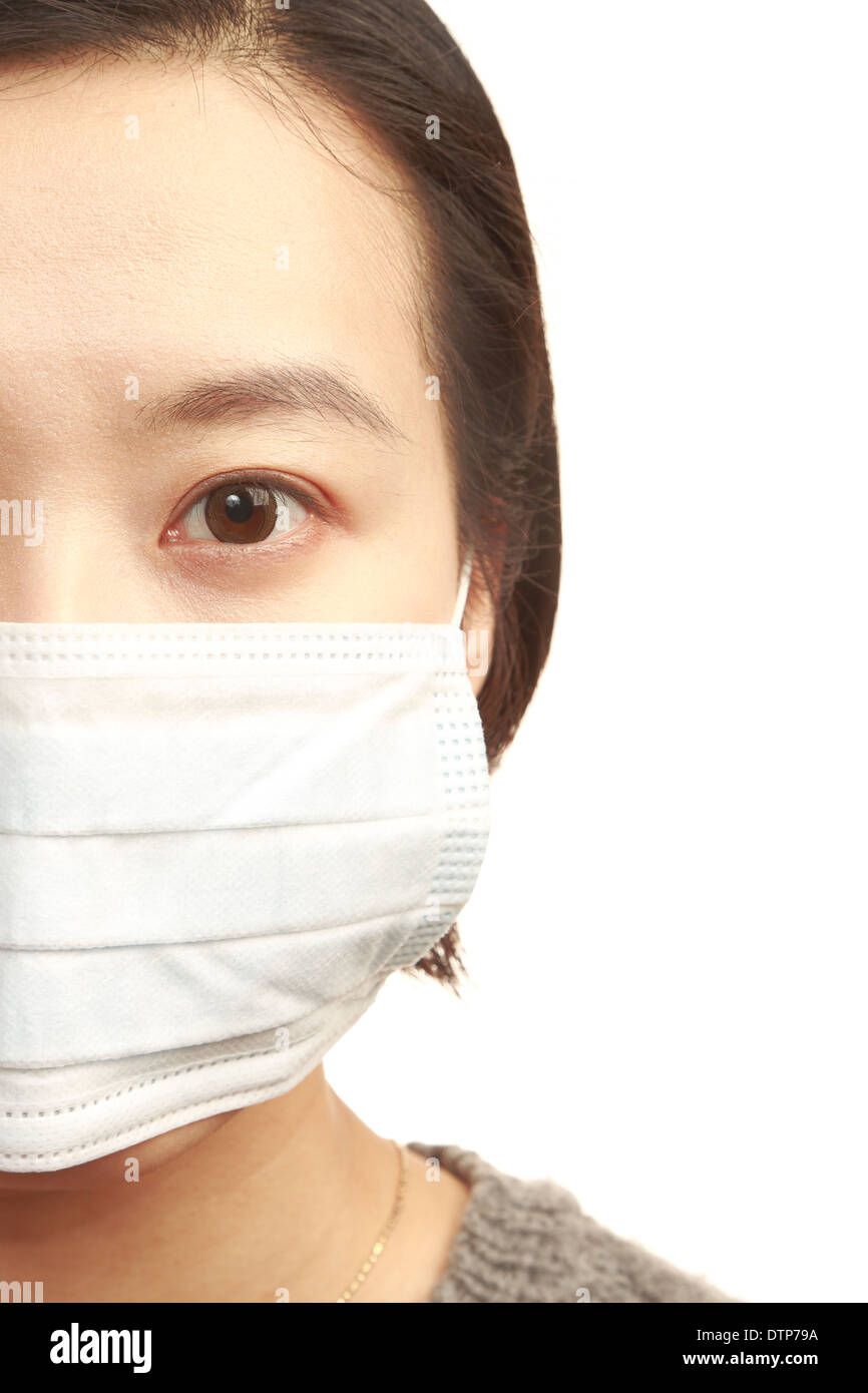 Asian woman wearing face mask on white background Stock Photo - Alamy