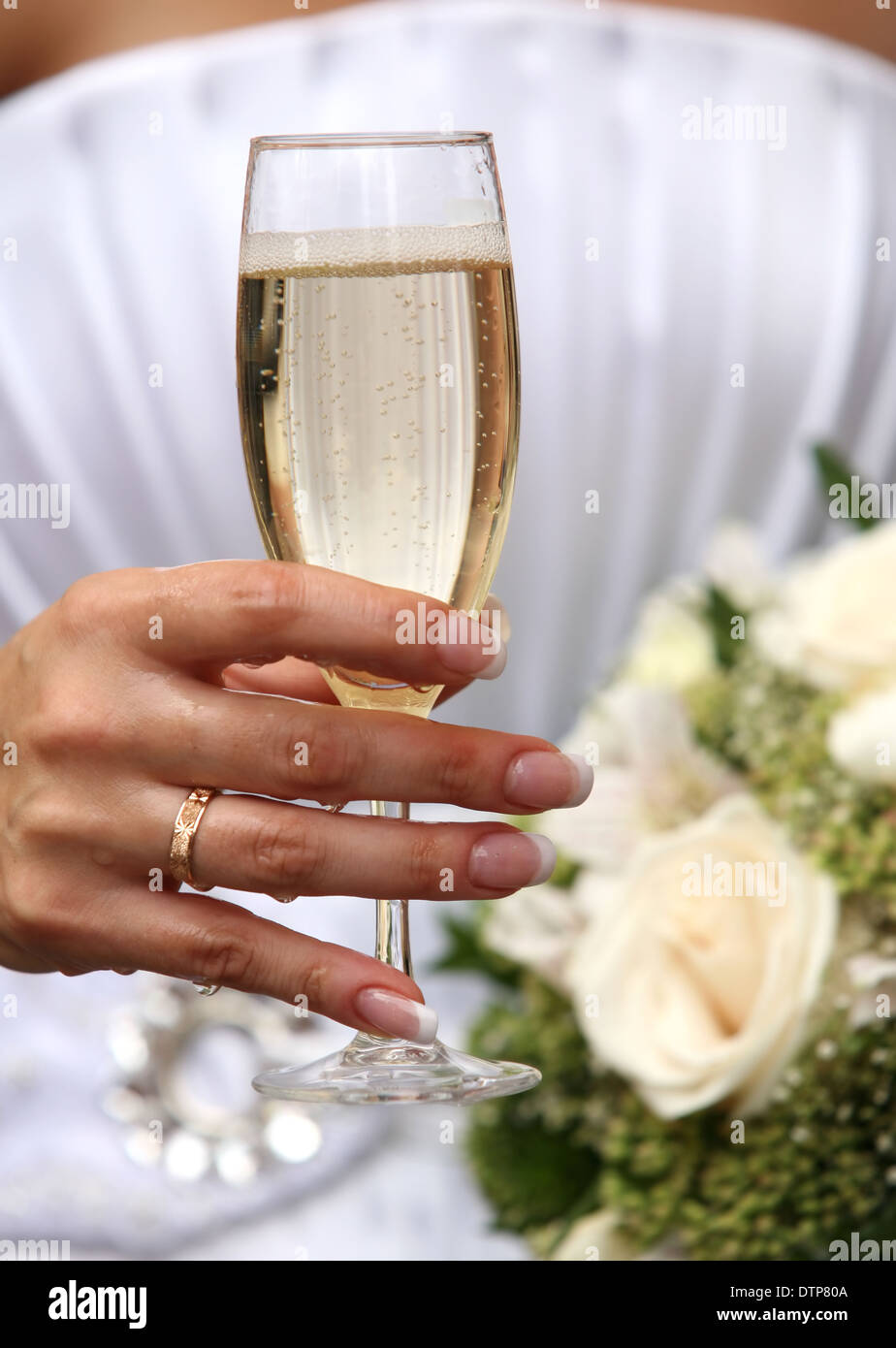 Glass of champagne in a hand of the bride Stock Photo - Alamy