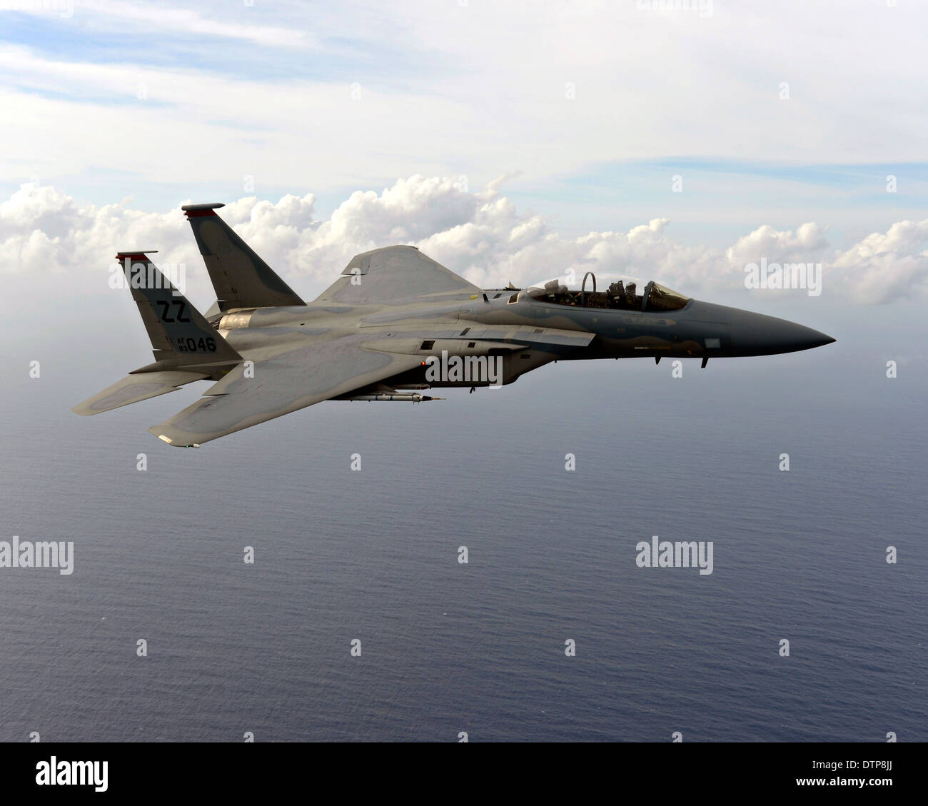 A US Air Force F-15 Eagle fighter aircraft flies over the Pacific Ocean ...