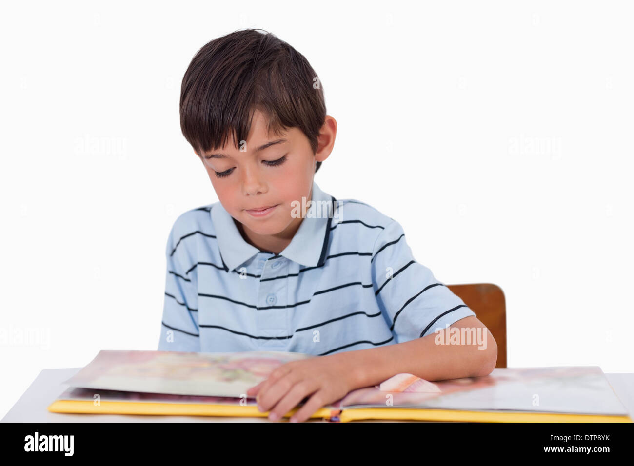 Boy reading a book Stock Photo - Alamy