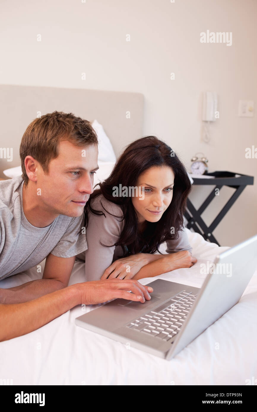 Couple using laptop in the bedroom together Stock Photo - Alamy