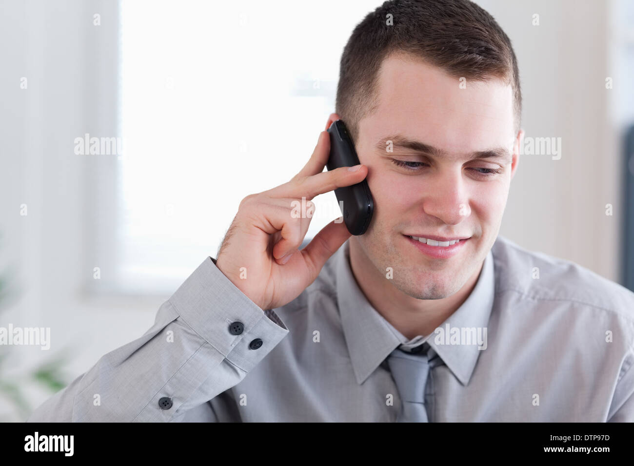 Businessman listening closely yo caller Stock Photo - Alamy