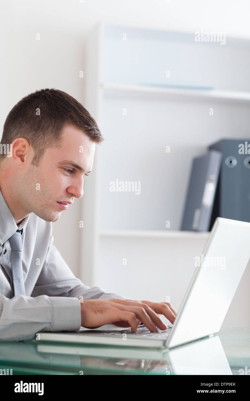 Businessman typing on his notebook Stock Photo - Alamy