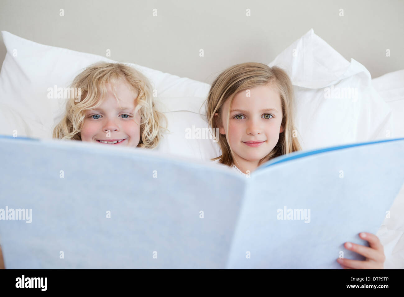 Brother and sister reading bedtime story Stock Photo - Alamy