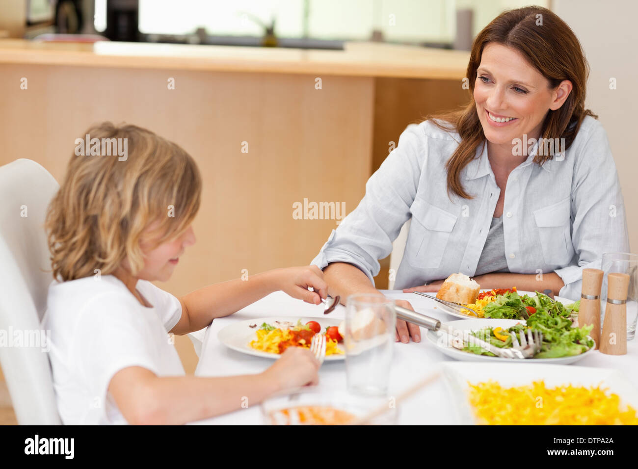 Side view of boy eating dinner Stock Photo - Alamy