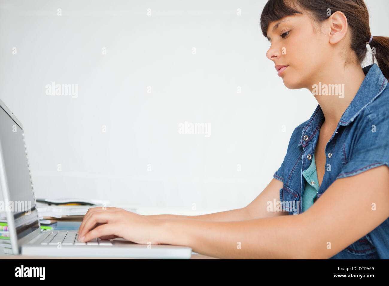 Side view of a student doing her homework Stock Photo - Alamy