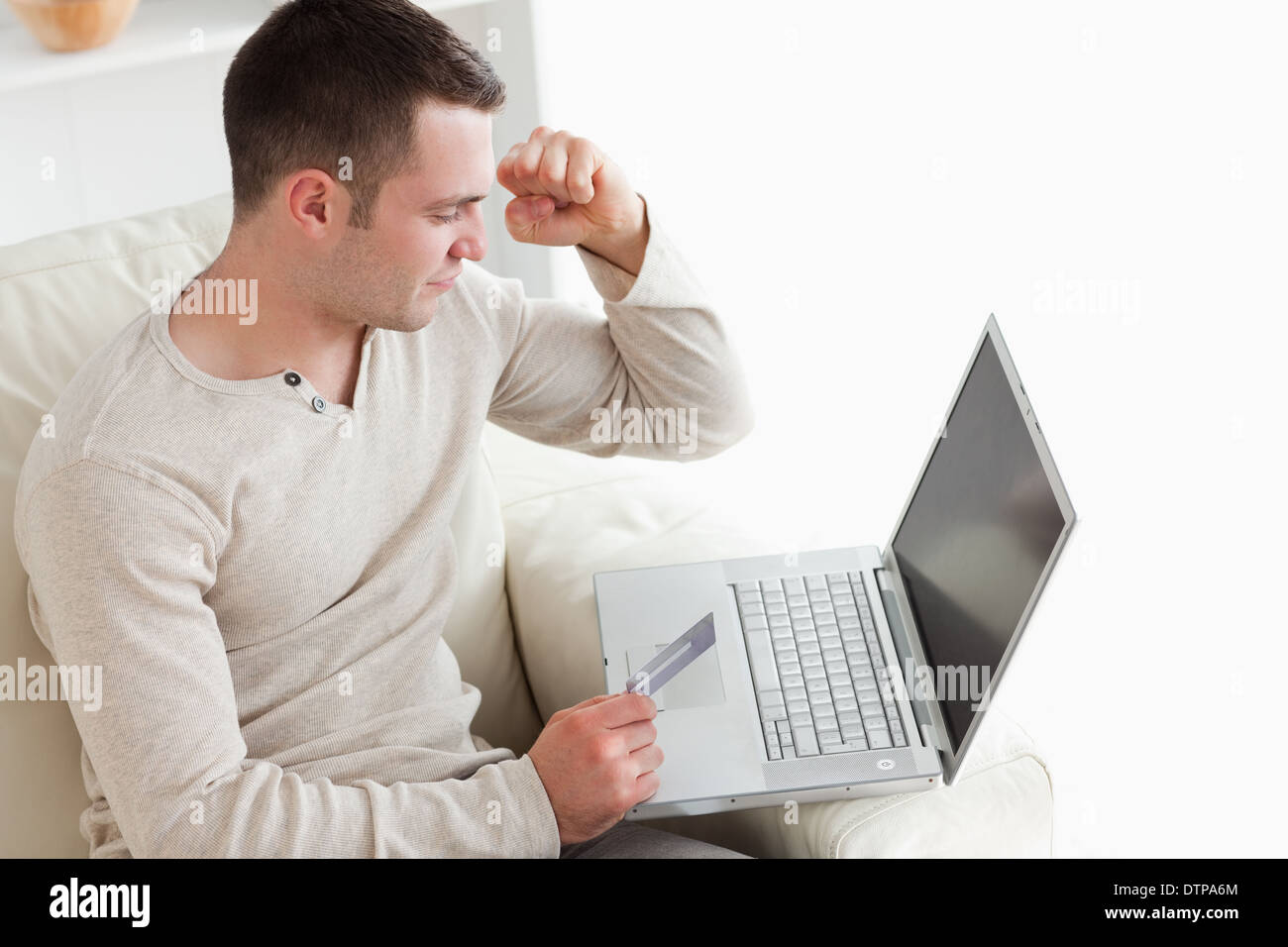 Happy man purchasing online Stock Photo - Alamy