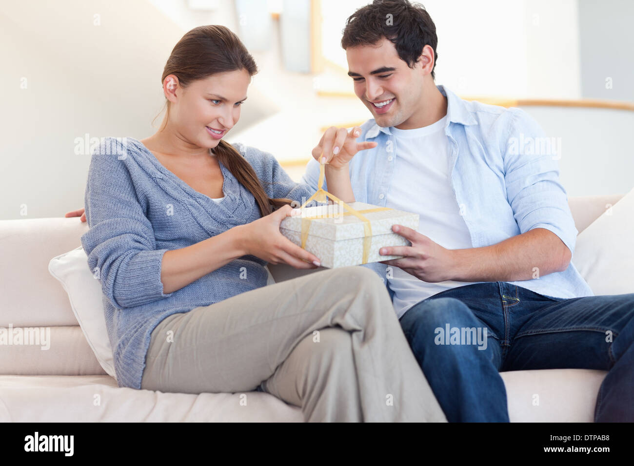 Man offering a gift to his wife Stock Photo - Alamy