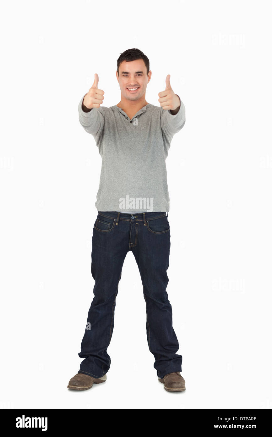 Young guy giving thumbs up Stock Photo - Alamy