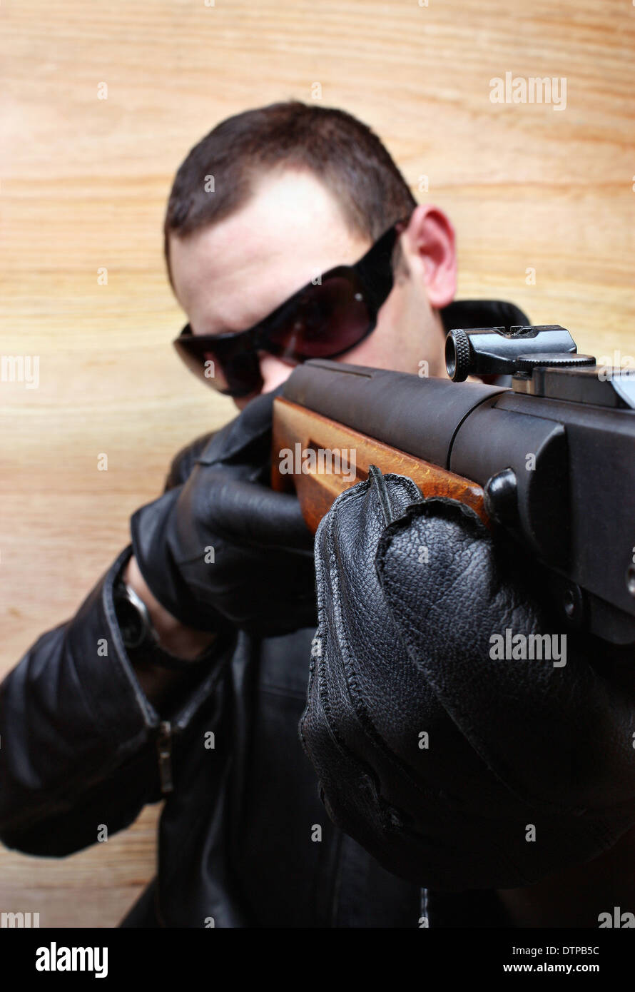 Menacing gangster mafia criminal shoots a gun Stock Photo - Alamy