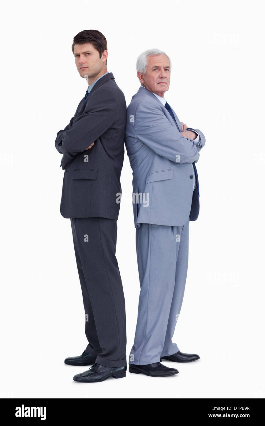 Businessmen standing back to back Stock Photo - Alamy