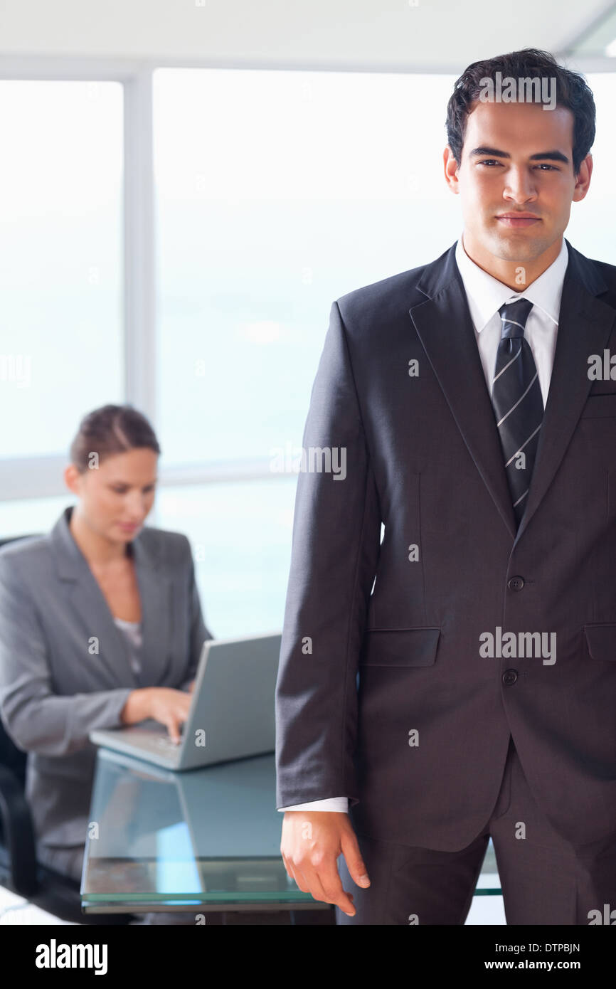 Tradesman with working colleague behind him Stock Photo - Alamy