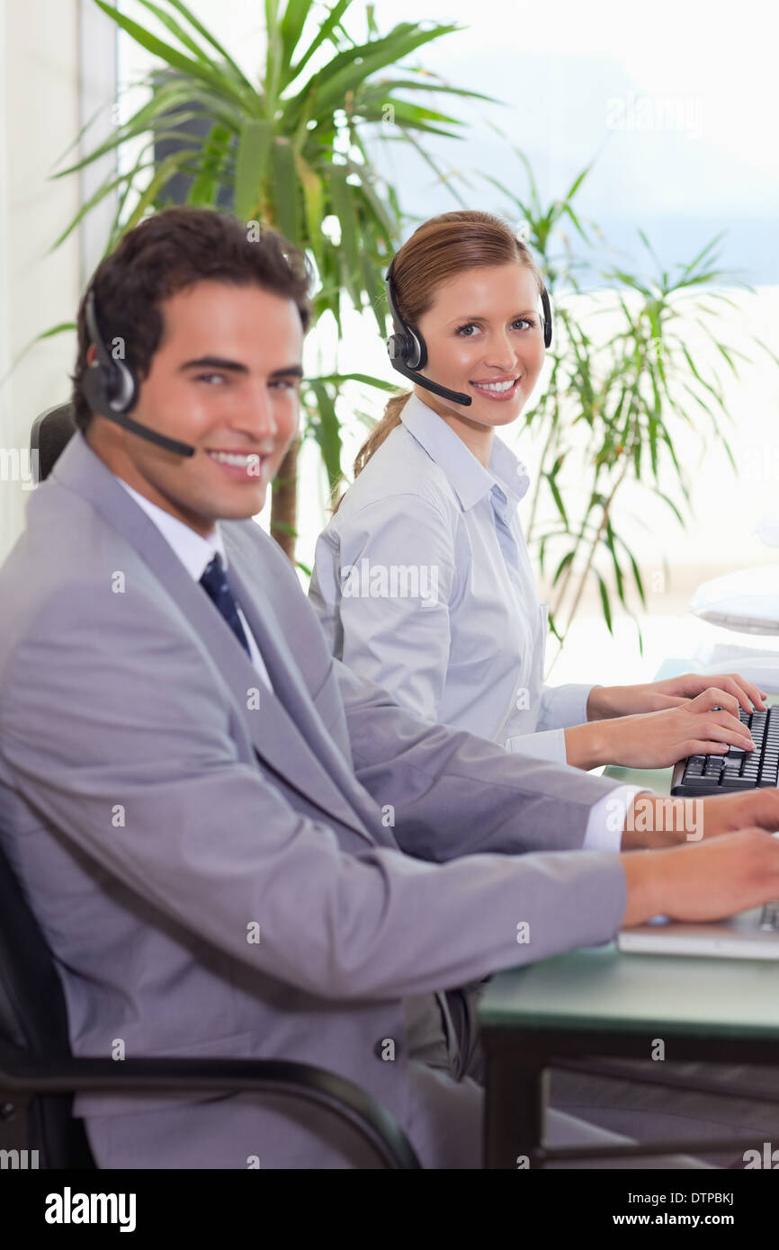 Side view of smiling call center agents Stock Photo - Alamy