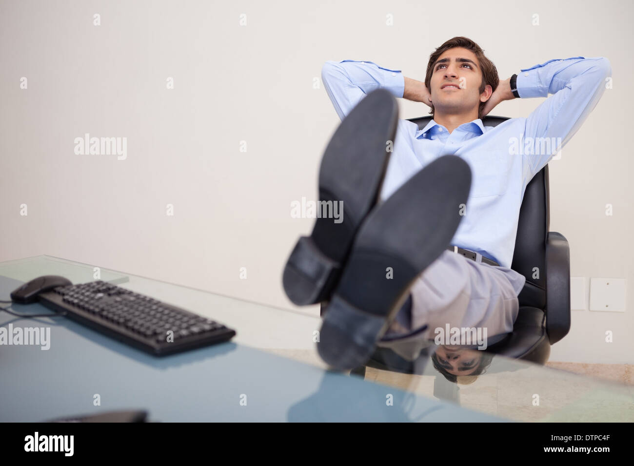 Leaning back in his chair hi-res stock photography and images - Alamy