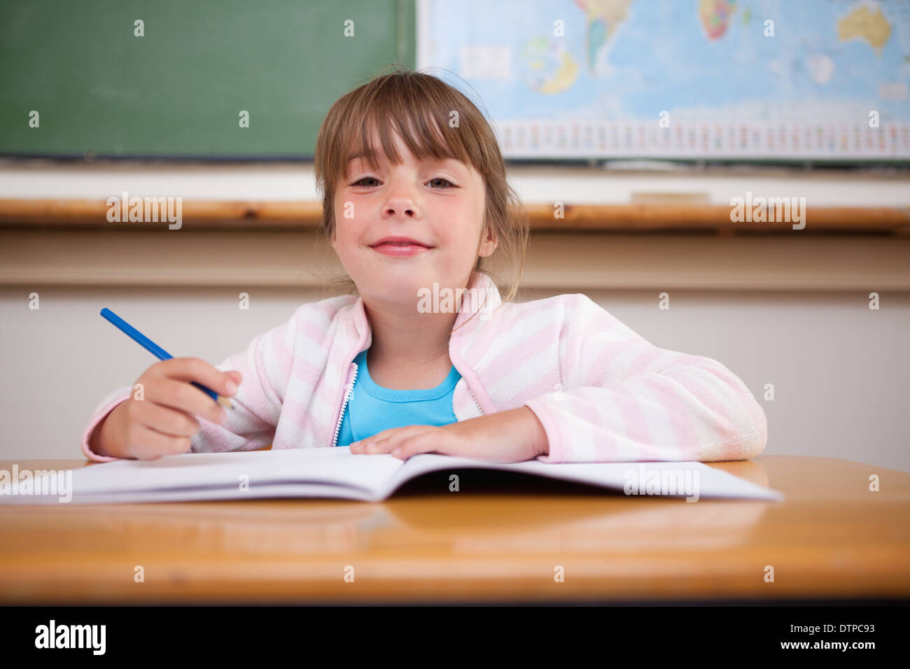 Cute girl writing Stock Photo - Alamy