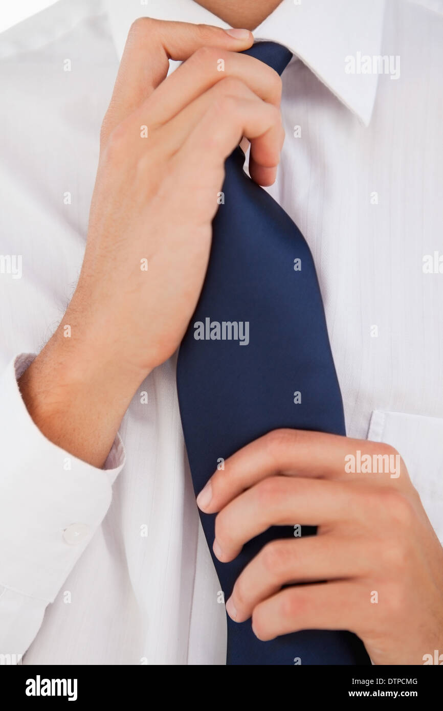 Man tightening his tie Stock Photo - Alamy