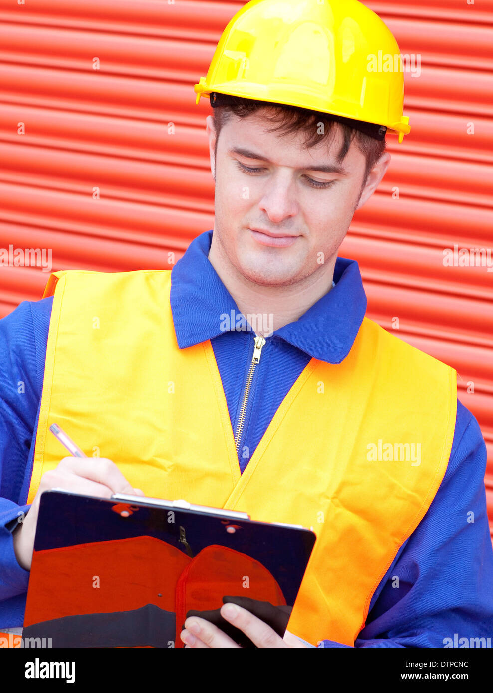Mature male engineer writing his report Stock Photo - Alamy