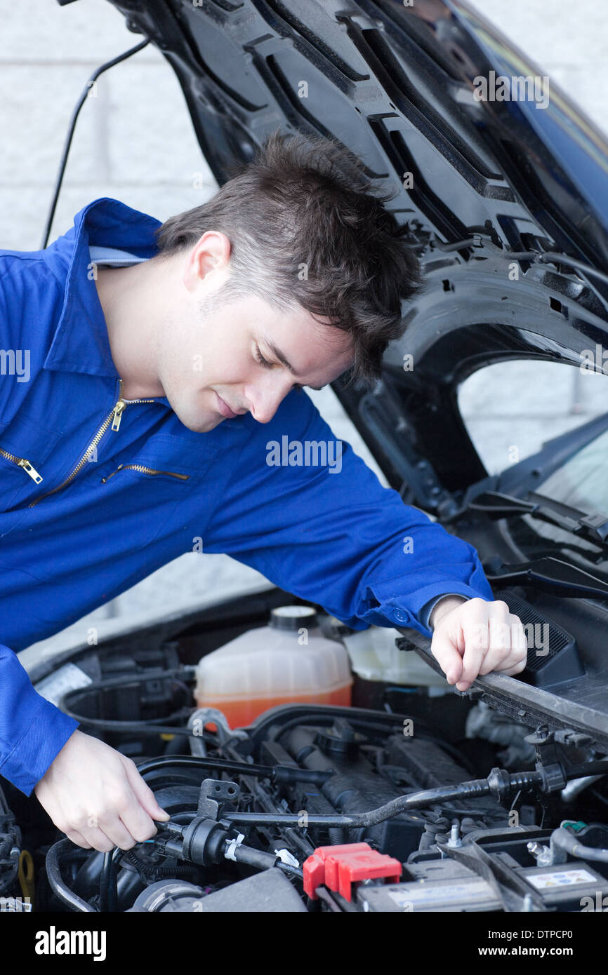 Concentrated man repairing a car Stock Photo - Alamy