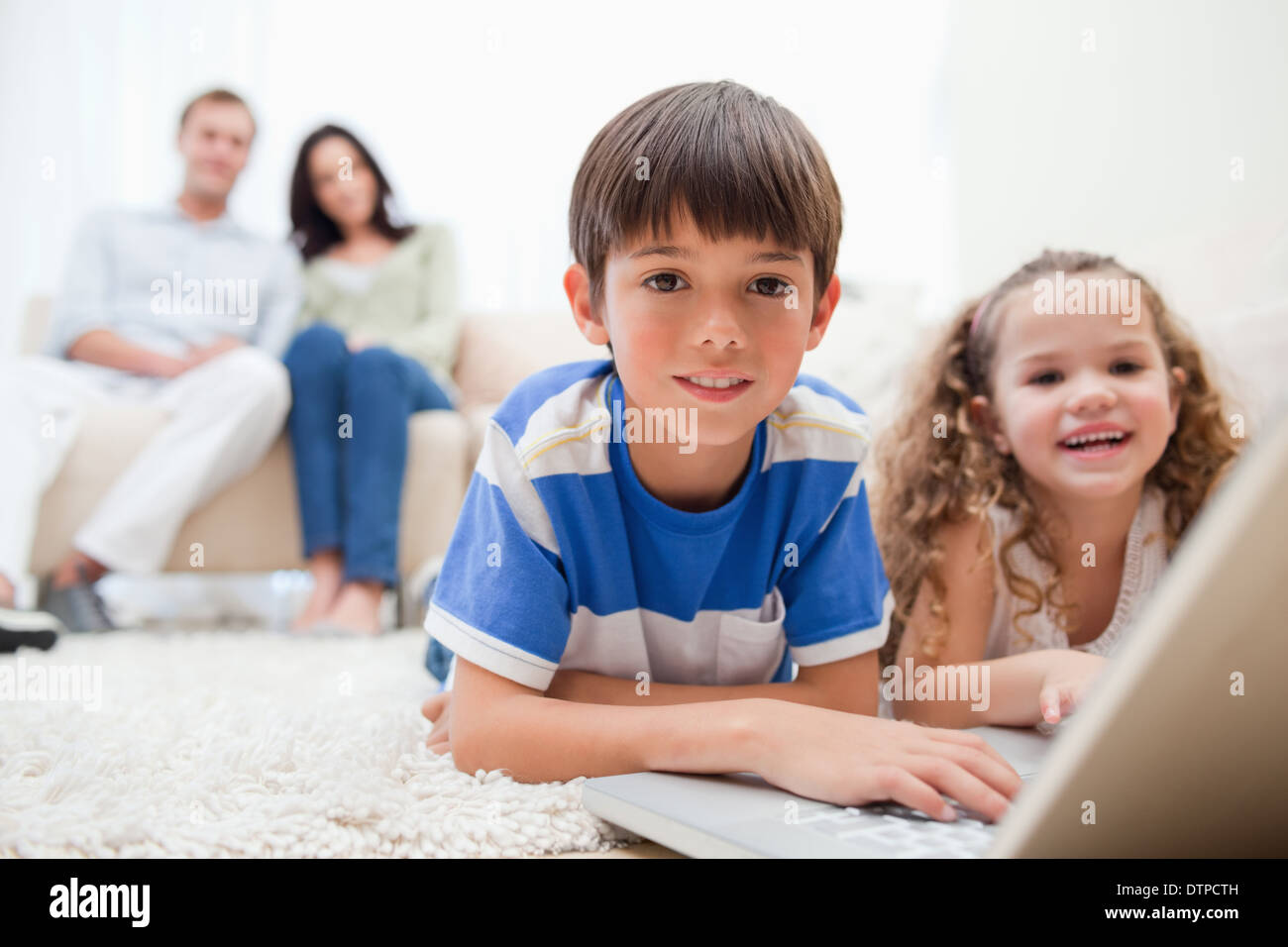 Cute kids playing computer games on laptop Stock Photo - Alamy