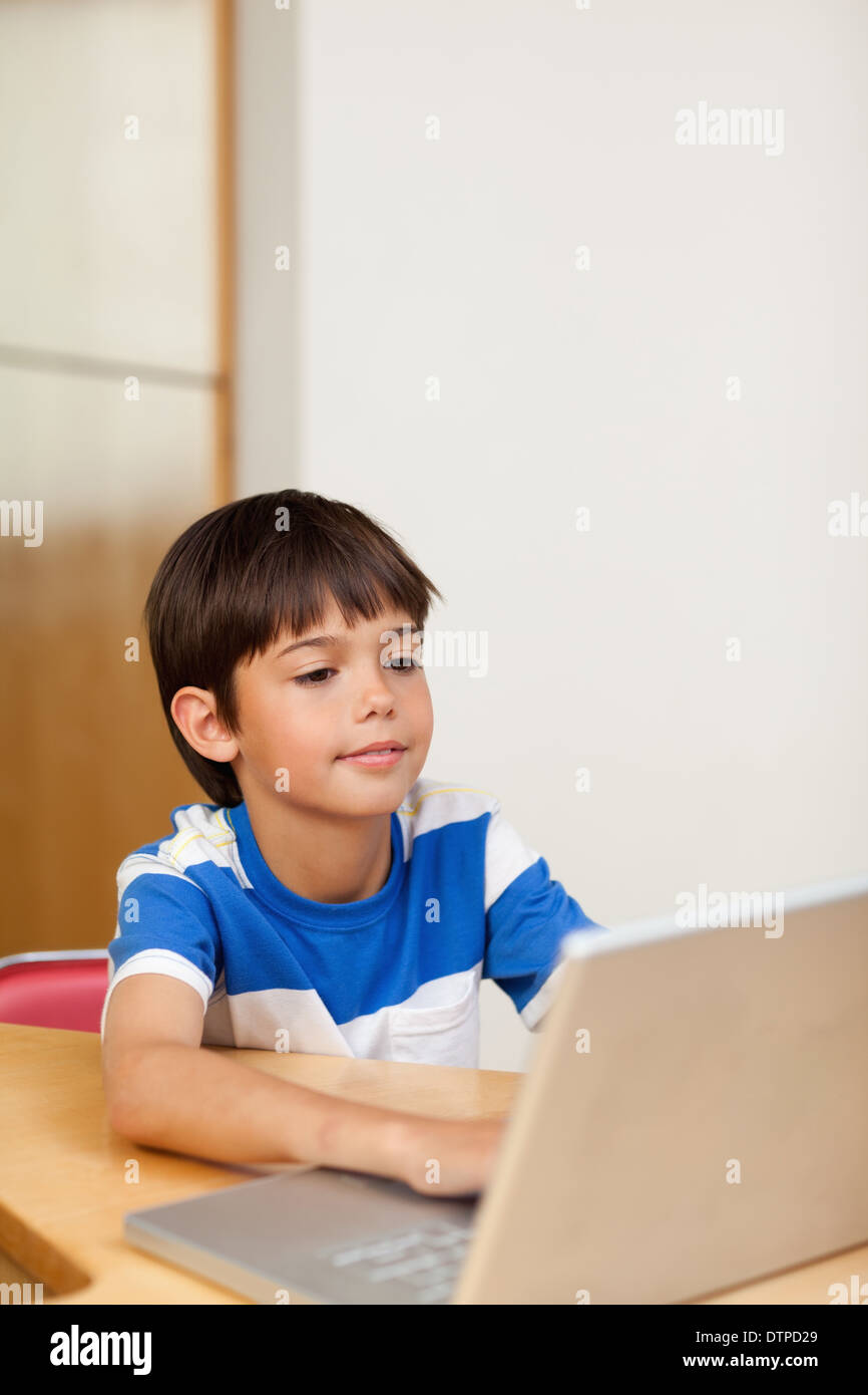 Boy playing computer games on the laptop Stock Photo - Alamy