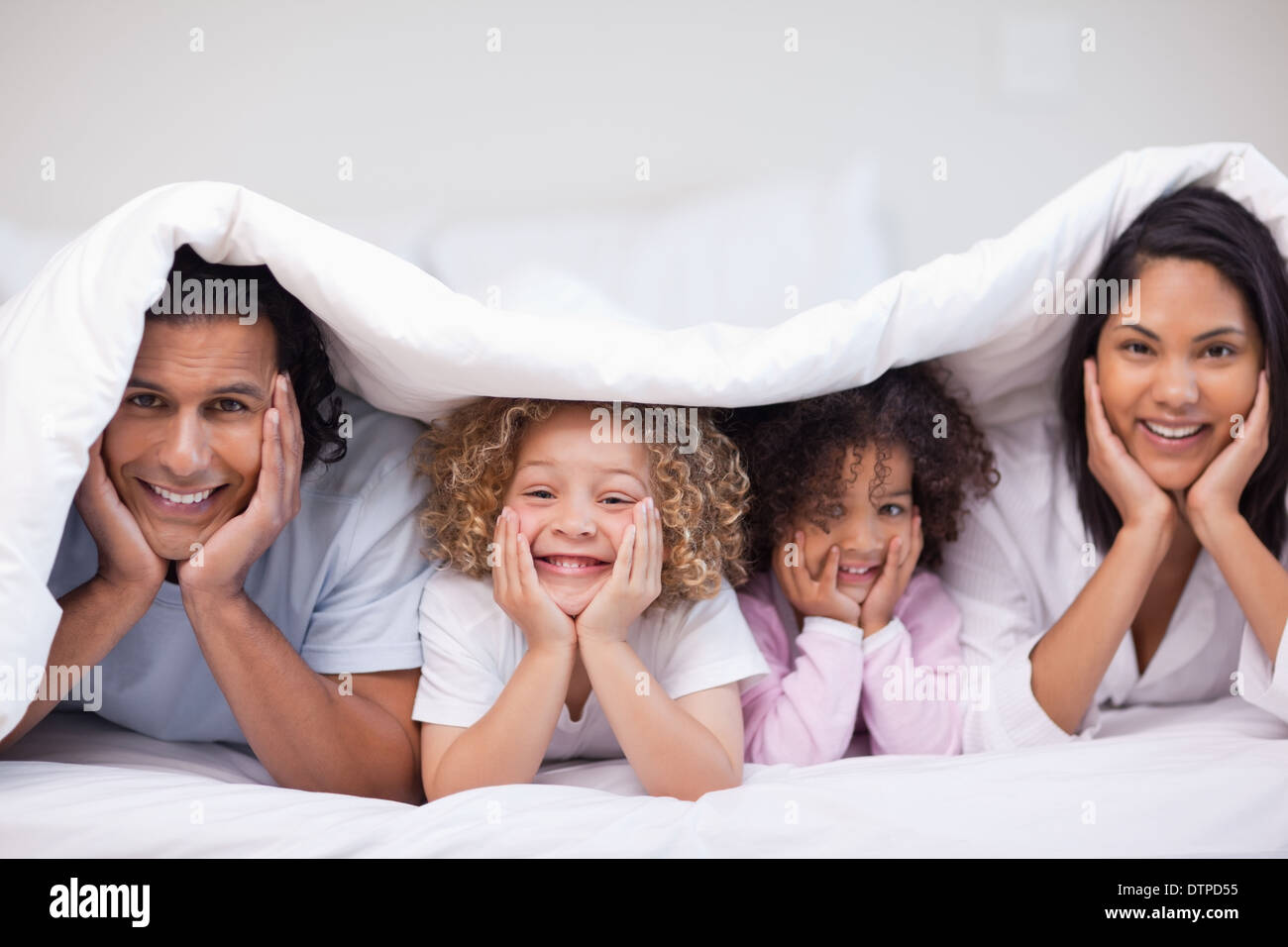 Family hiding under the blanket Stock Photo - Alamy