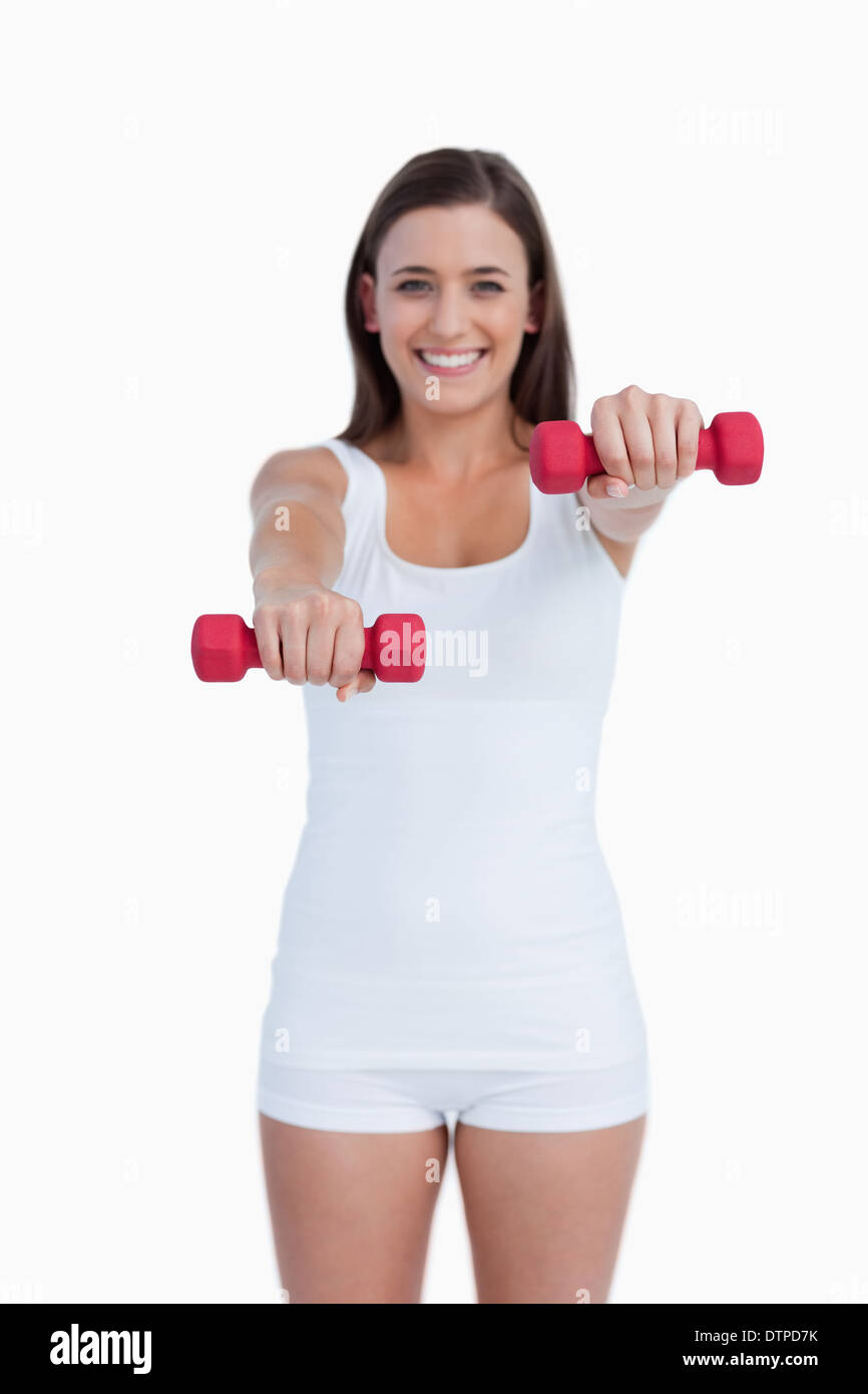 Red weights being held by a young brunette Stock Photo - Alamy