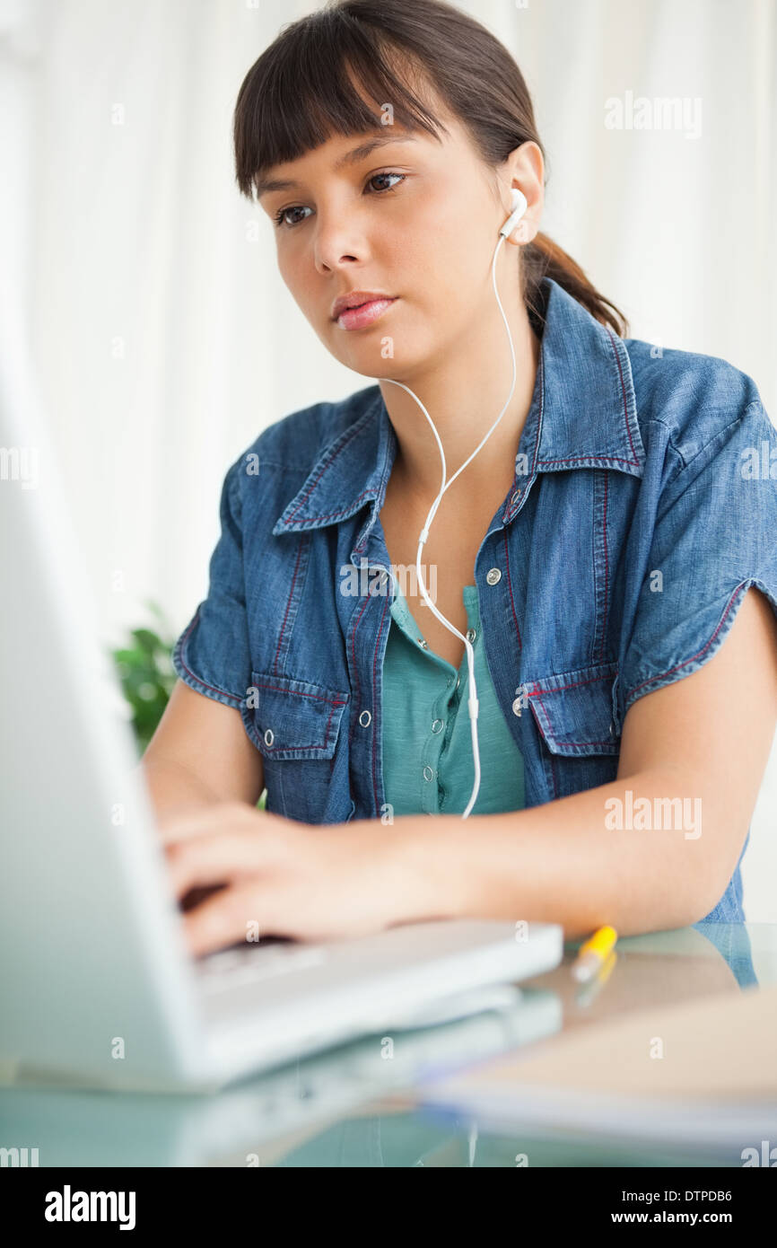 Female student doing her homework with music Stock Photo - Alamy