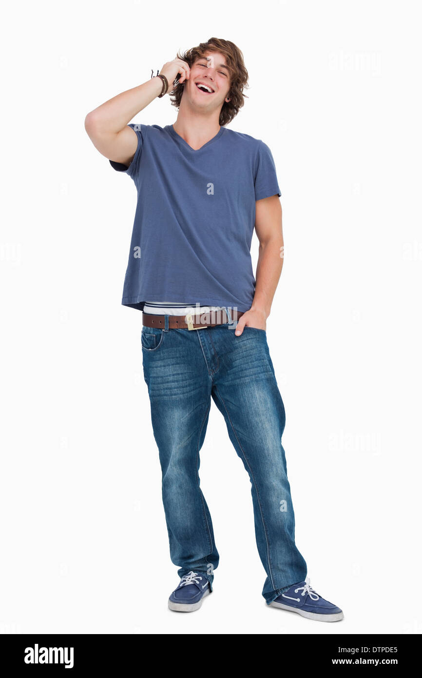 Standing male student laughing while calling Stock Photo - Alamy