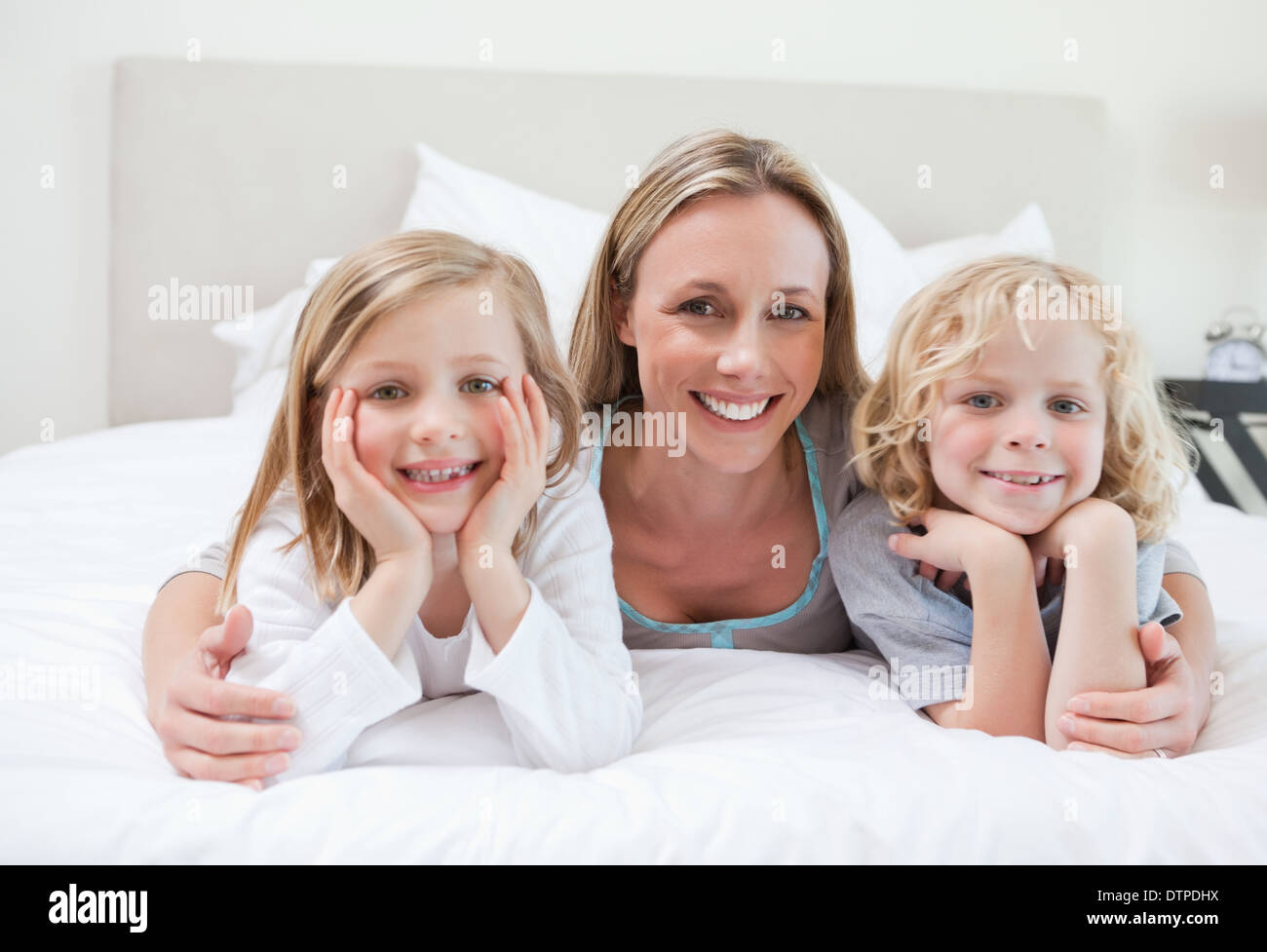 Mother embracing her children Stock Photo - Alamy