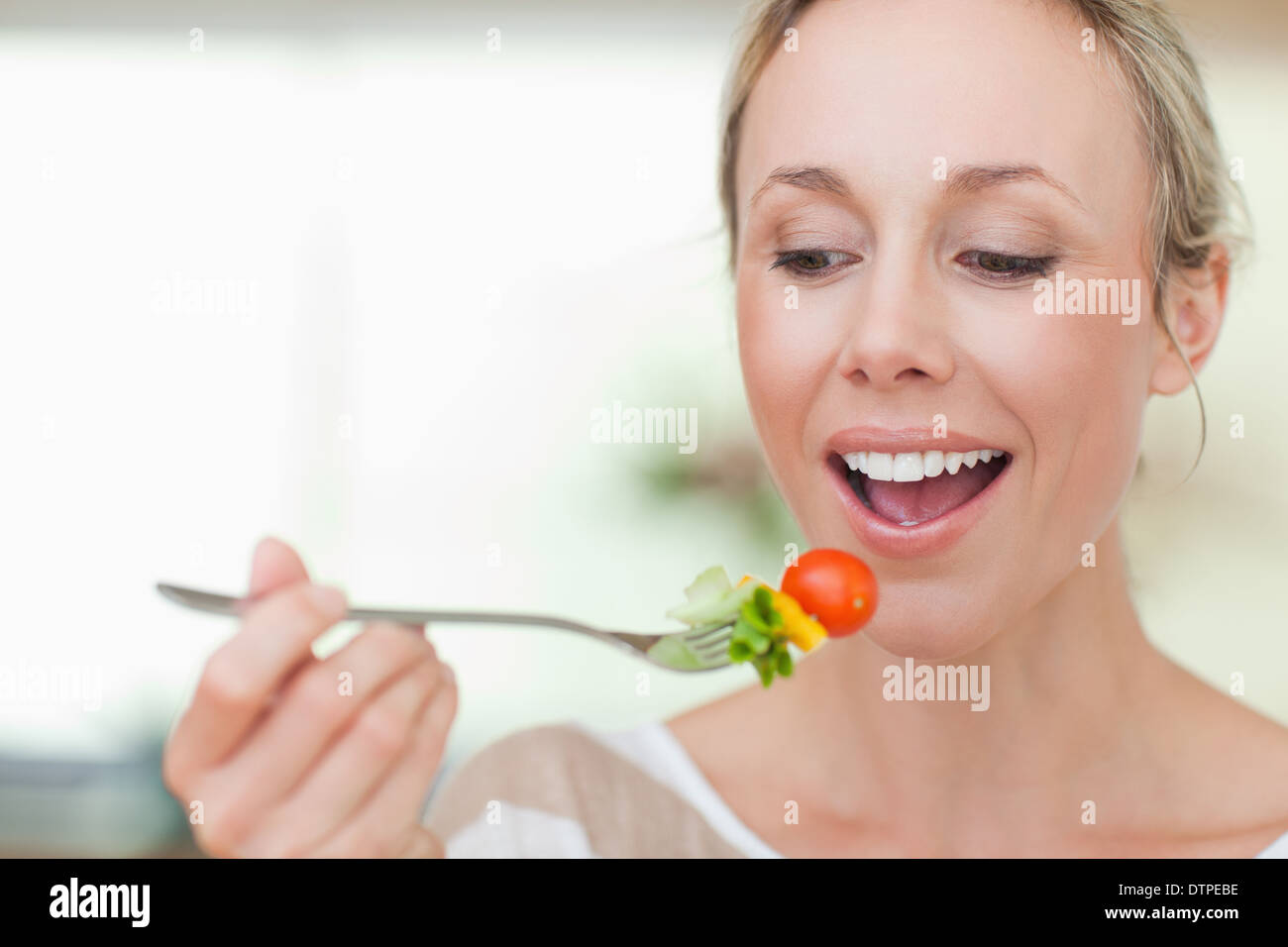 Woman eating a tomato Stock Photo - Alamy