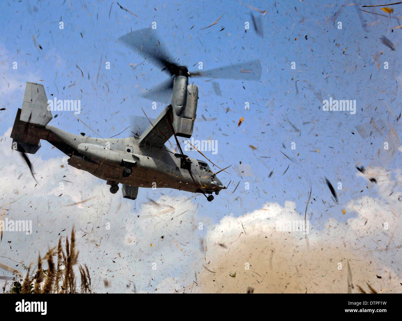 A US Marine Corps MV-22B Osprey tilt rotor aircraft prepares to land ...