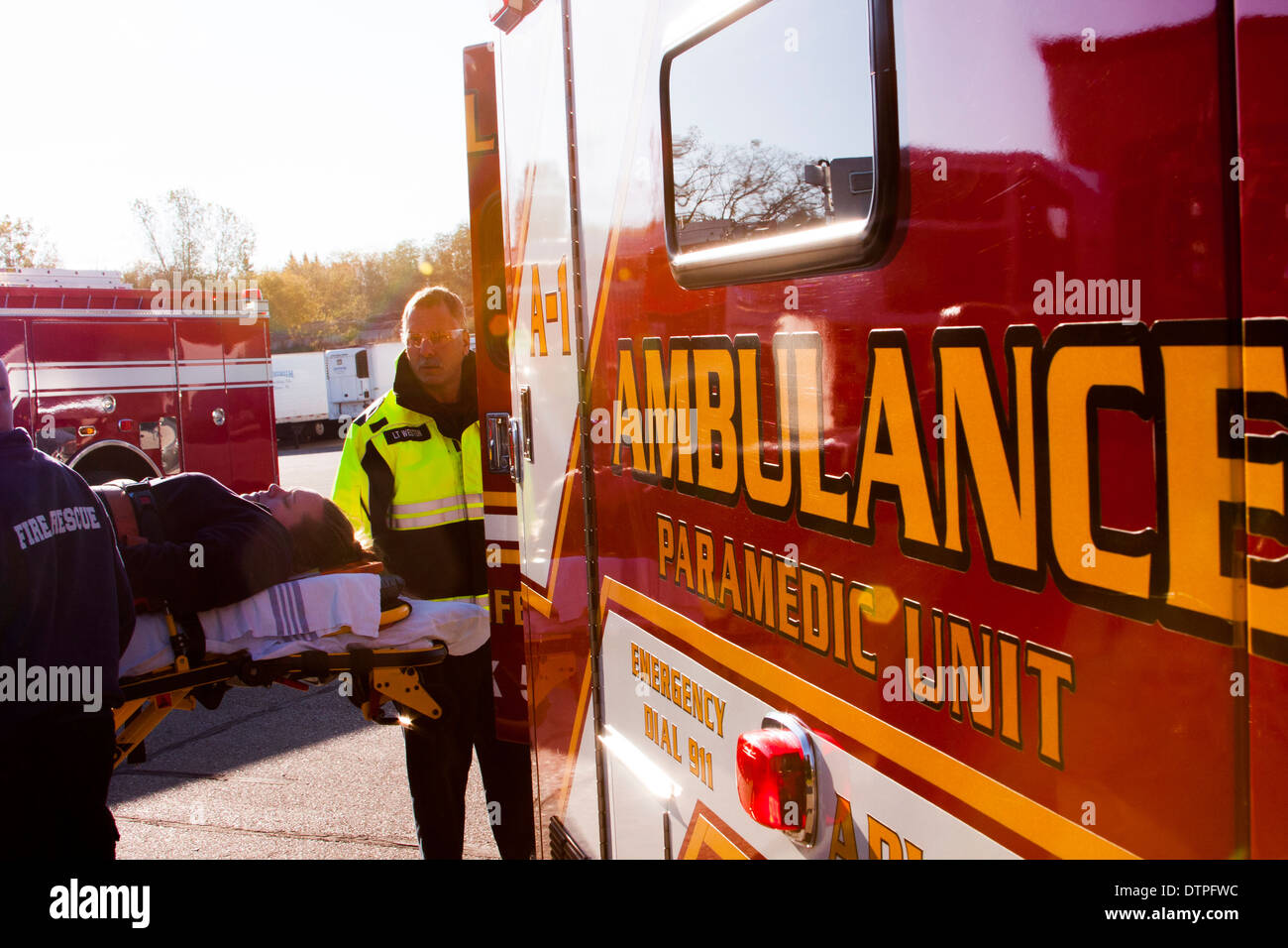 An EMT loading a patient into the back of an Ambulance Stock Photo - Alamy