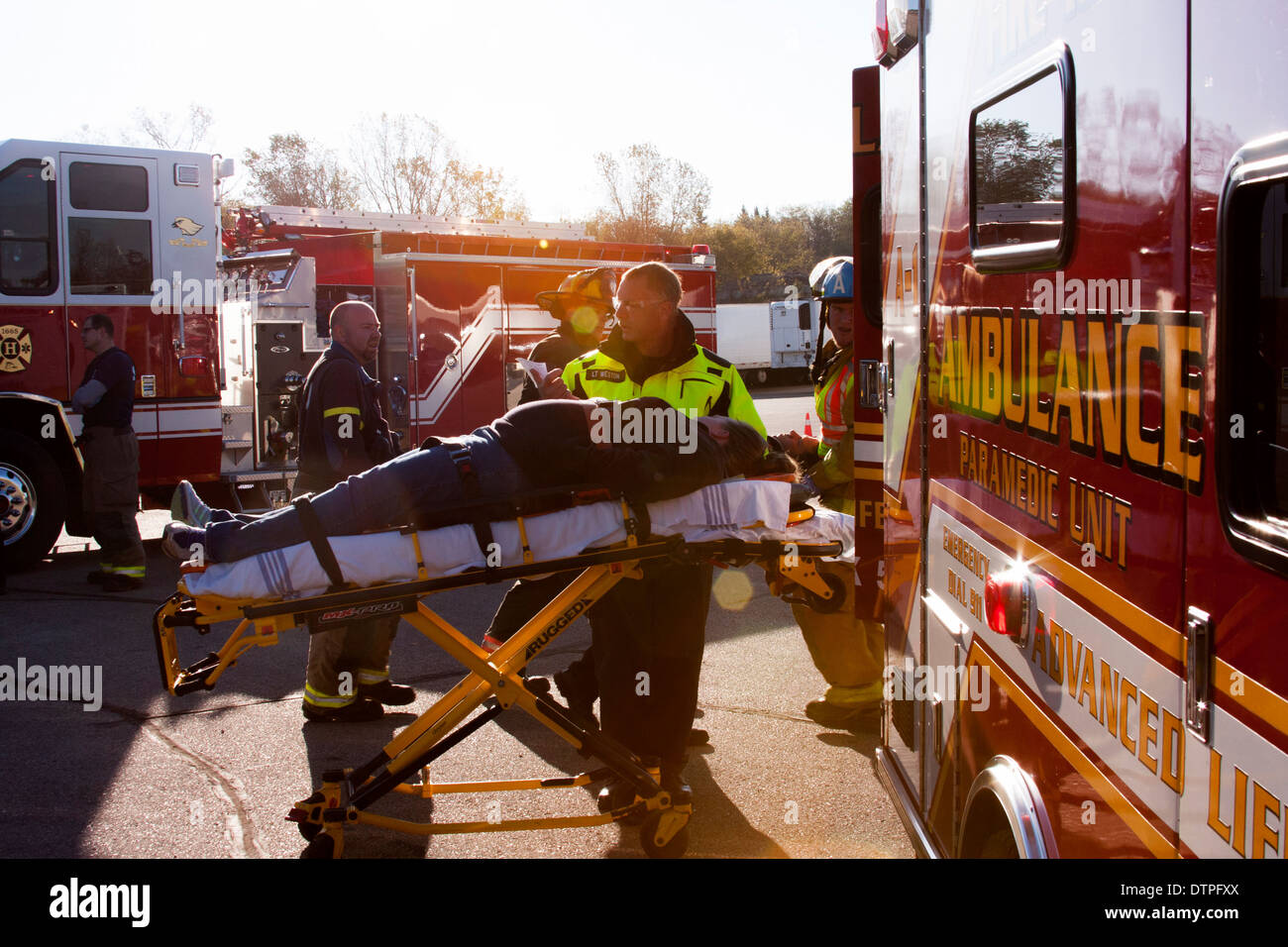 An EMT loading a patient into the back of an Ambulance Stock Photo - Alamy