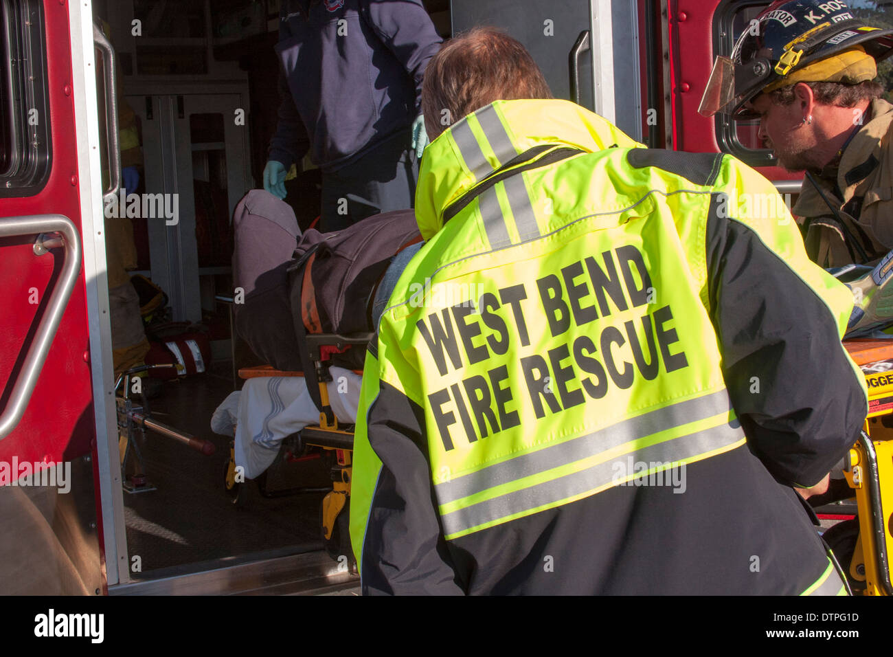 An EMT loading a patient into the back of an Ambulance Stock Photo - Alamy