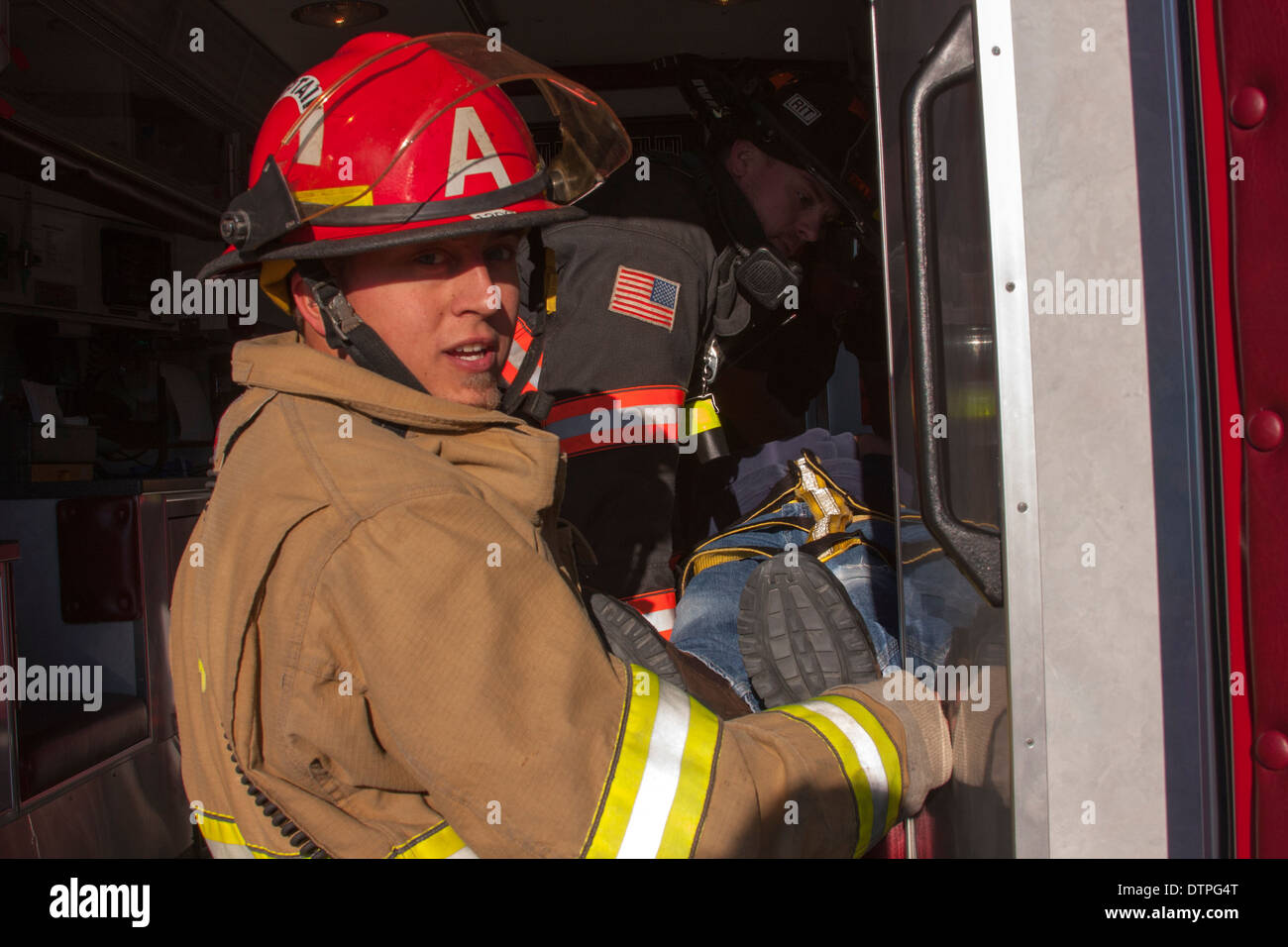 An EMT loading a patient into the back of an Ambulance Stock Photo - Alamy