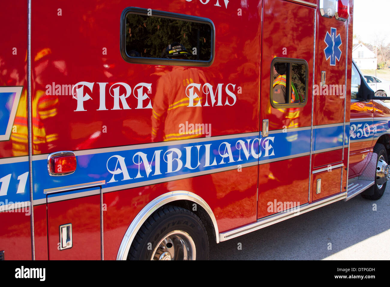 EMT and firefighters reflected on the side of an ambulance Stock Photo ...