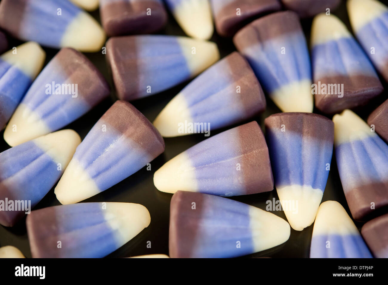 Wildberry flavored candy corn on a black background Stock Photo - Alamy