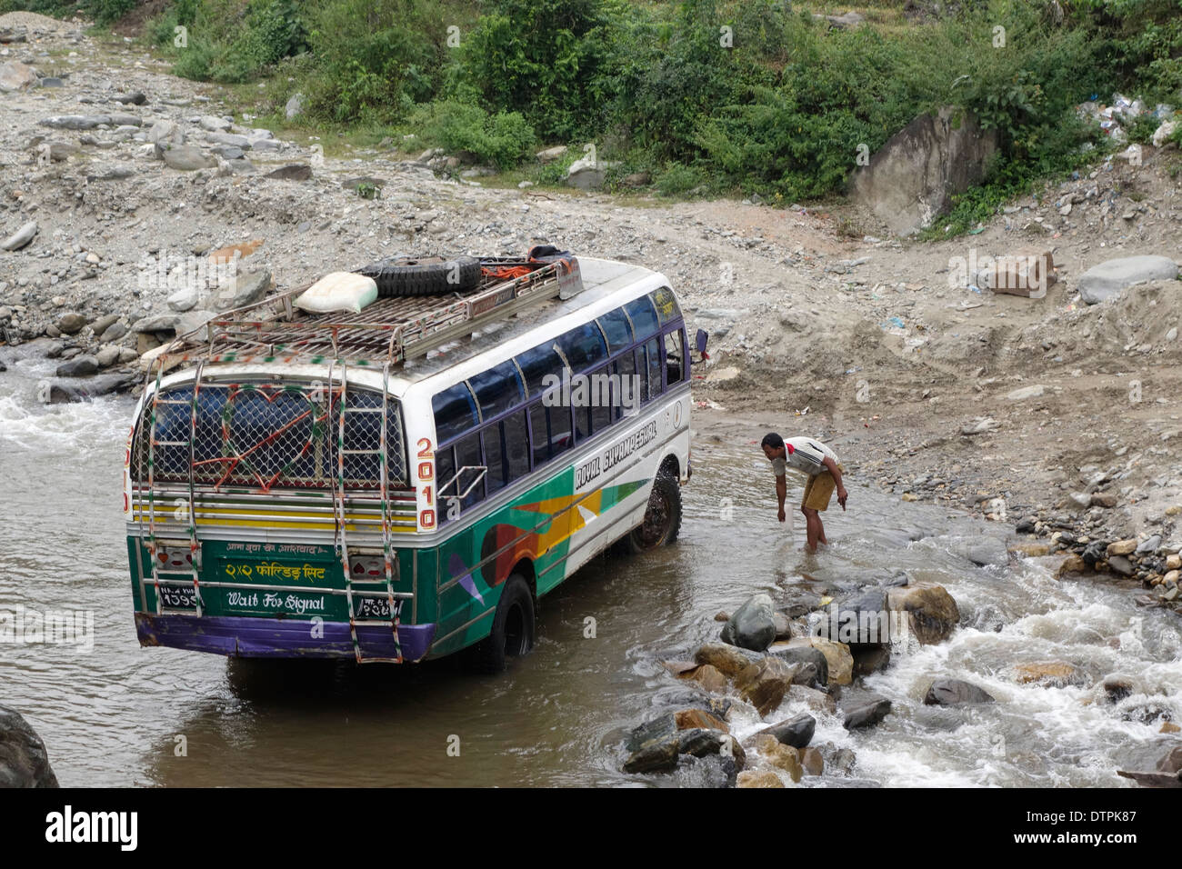 Washing a bus in a stream in the Gorkha region of Nepal Stock Photo - Alamy