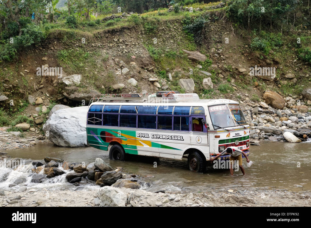 Washing a bus in a stream in the Gorkha region of Nepal Stock Photo - Alamy
