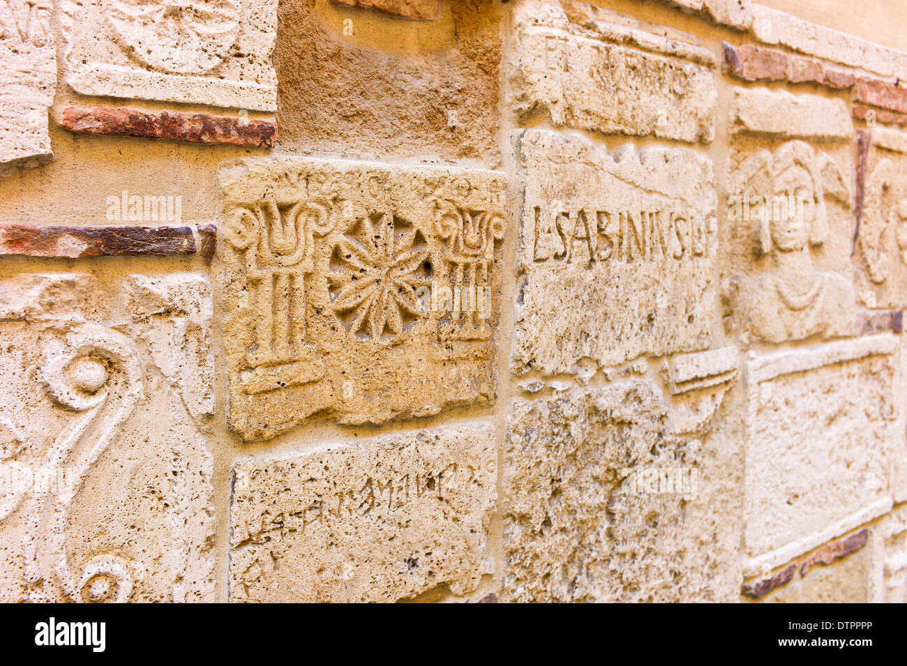 Roman and Etruscan stone carving reliefs inset to the wall of Palazzo ...