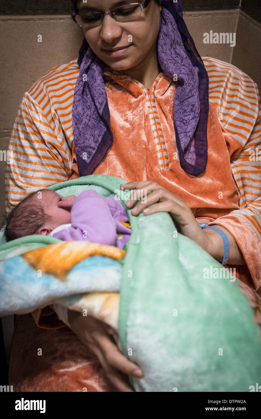 Cairo, Egypt. 22nd Feb, 2014. A new-born baby lies in the arms of its ...
