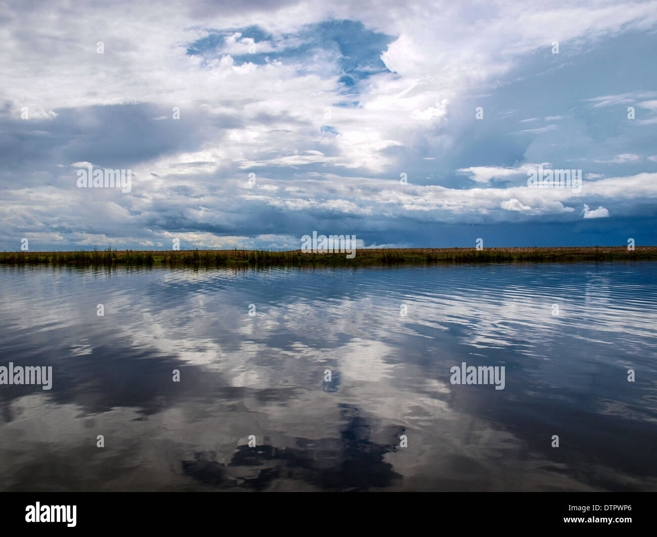 Chobe river landscape with sky reflected in the water Stock Photo - Alamy