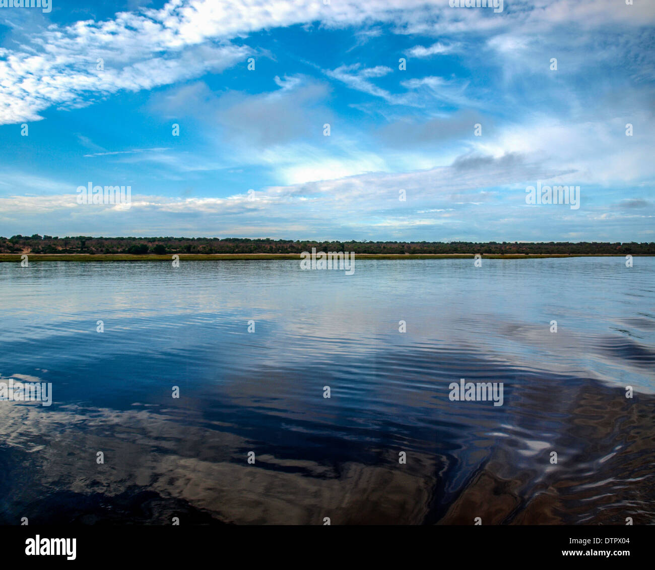 Chobe river landscape with sky reflected in the water Stock Photo - Alamy